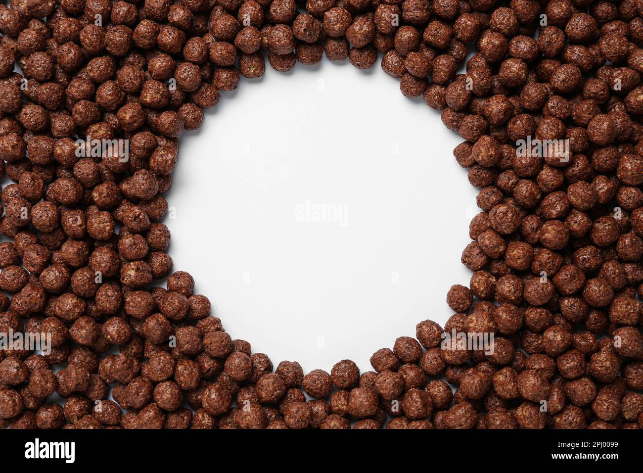Frame of sweet crispy chocolate corn balls on white background, top ...