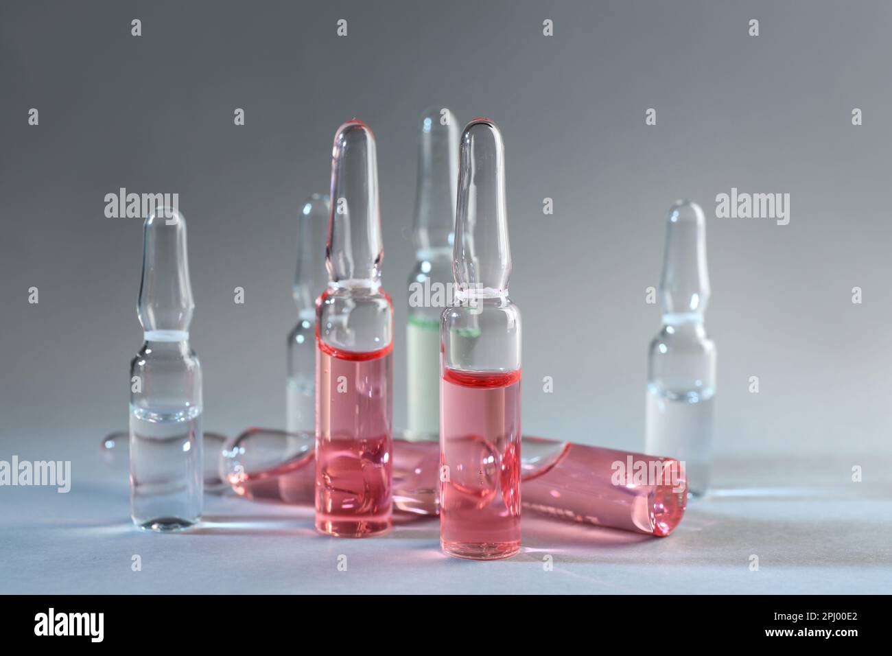 Different pharmaceutical ampoules on light grey background Stock Photo ...