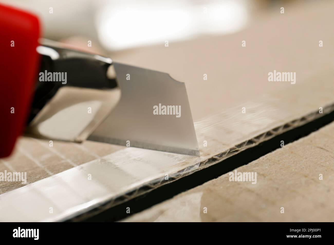 Using utility knife to open parcel, closeup Stock Photo - Alamy