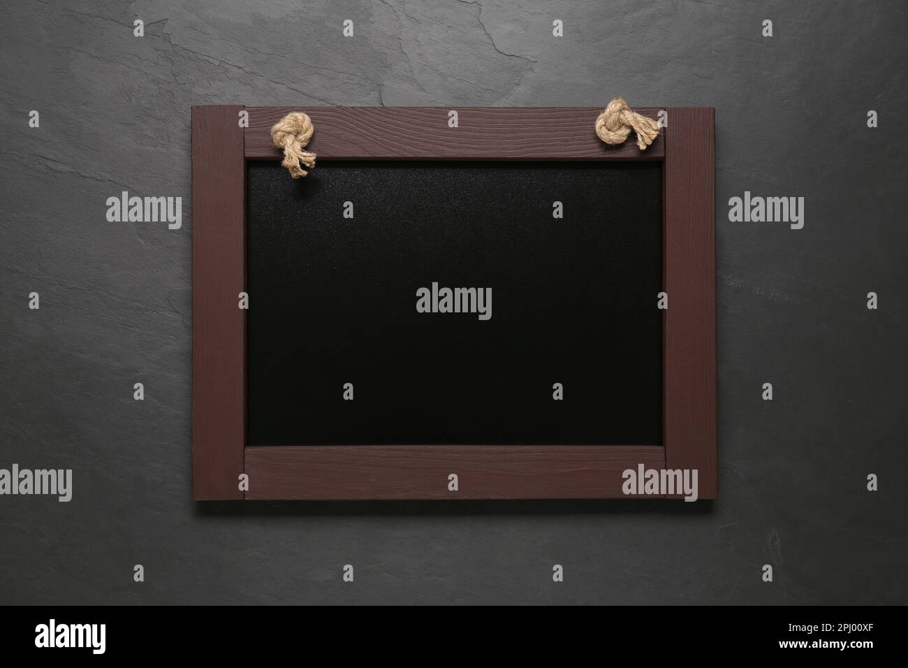 Clean small black chalkboard on dark table, top view Stock Photo - Alamy