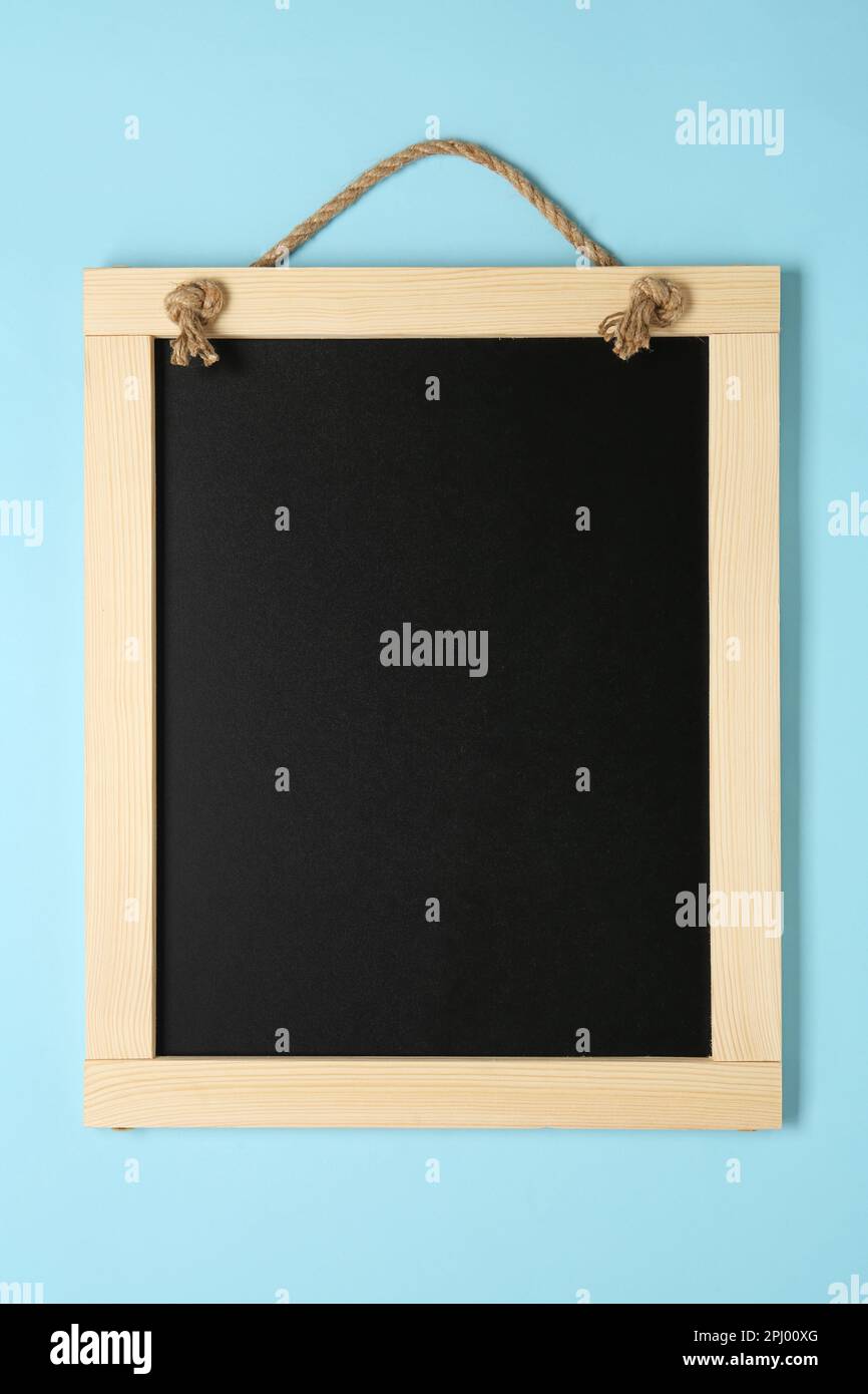 Clean small black chalkboard on light blue background, top view Stock ...