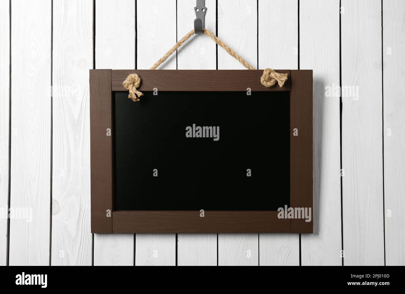 Clean small black chalkboard hanging on white wooden wall Stock Photo ...