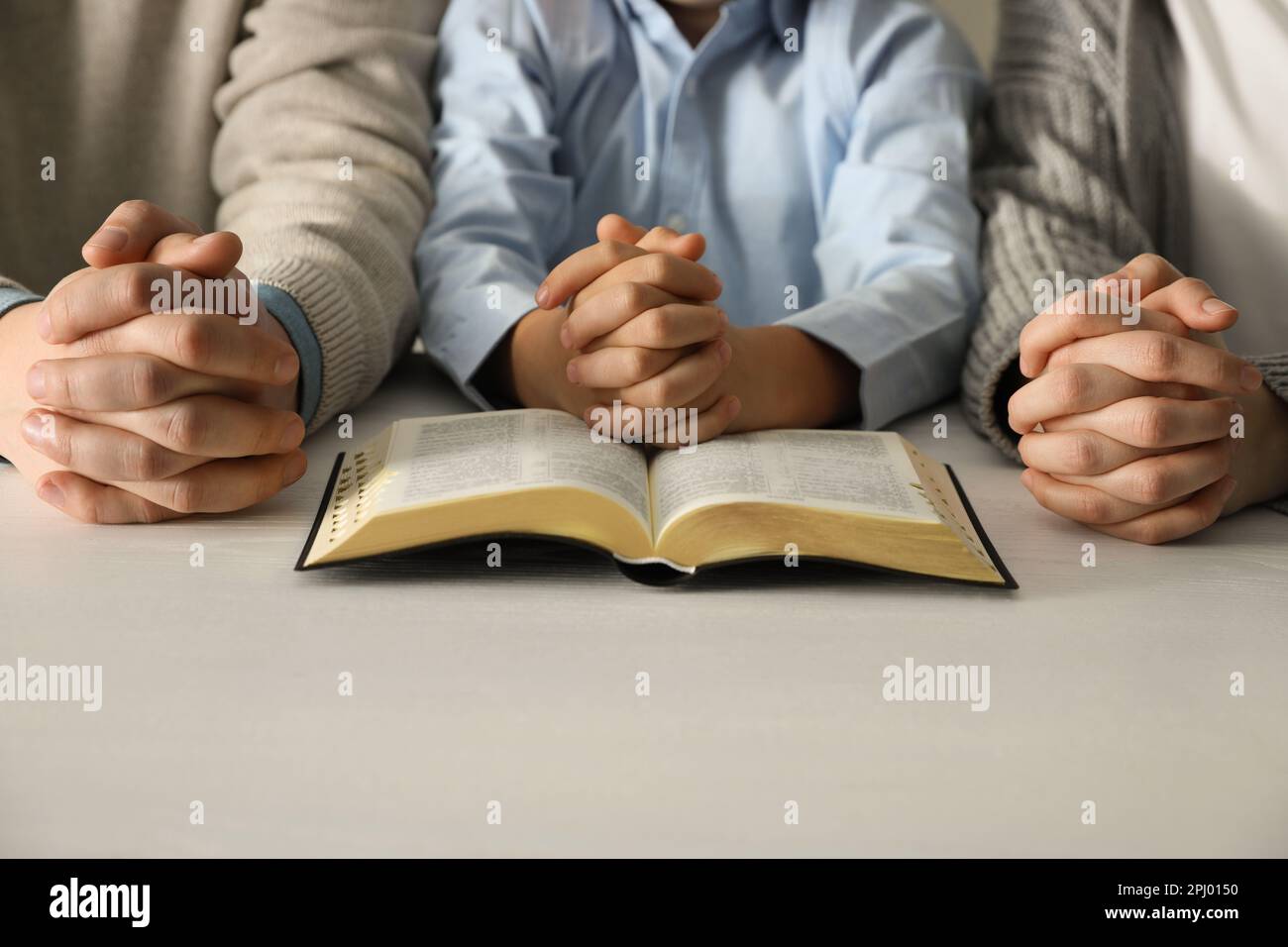 Boy godparents praying together hi-res stock photography and images - Alamy
