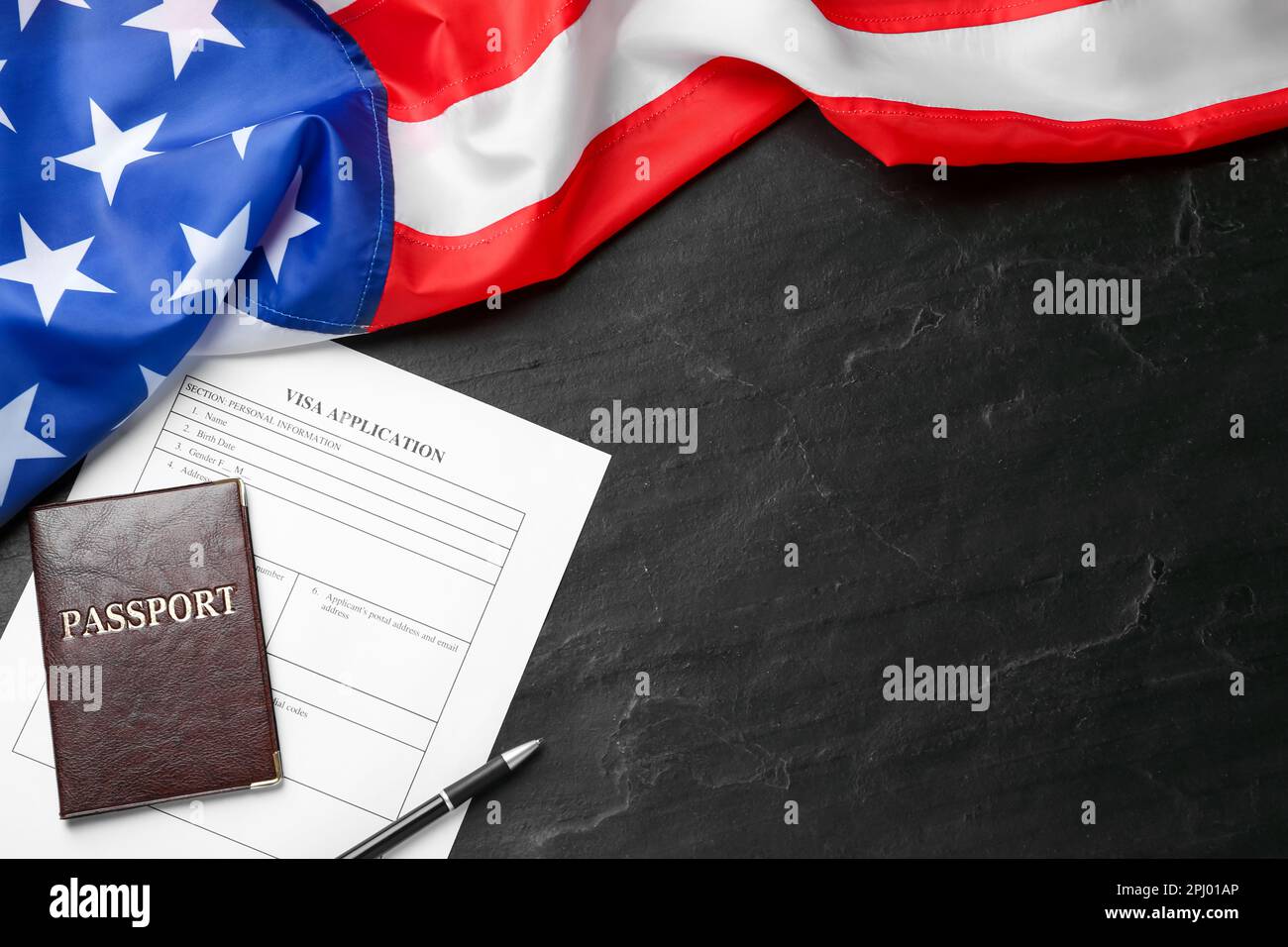 American flag, visa application form and passport on black table, flat ...
