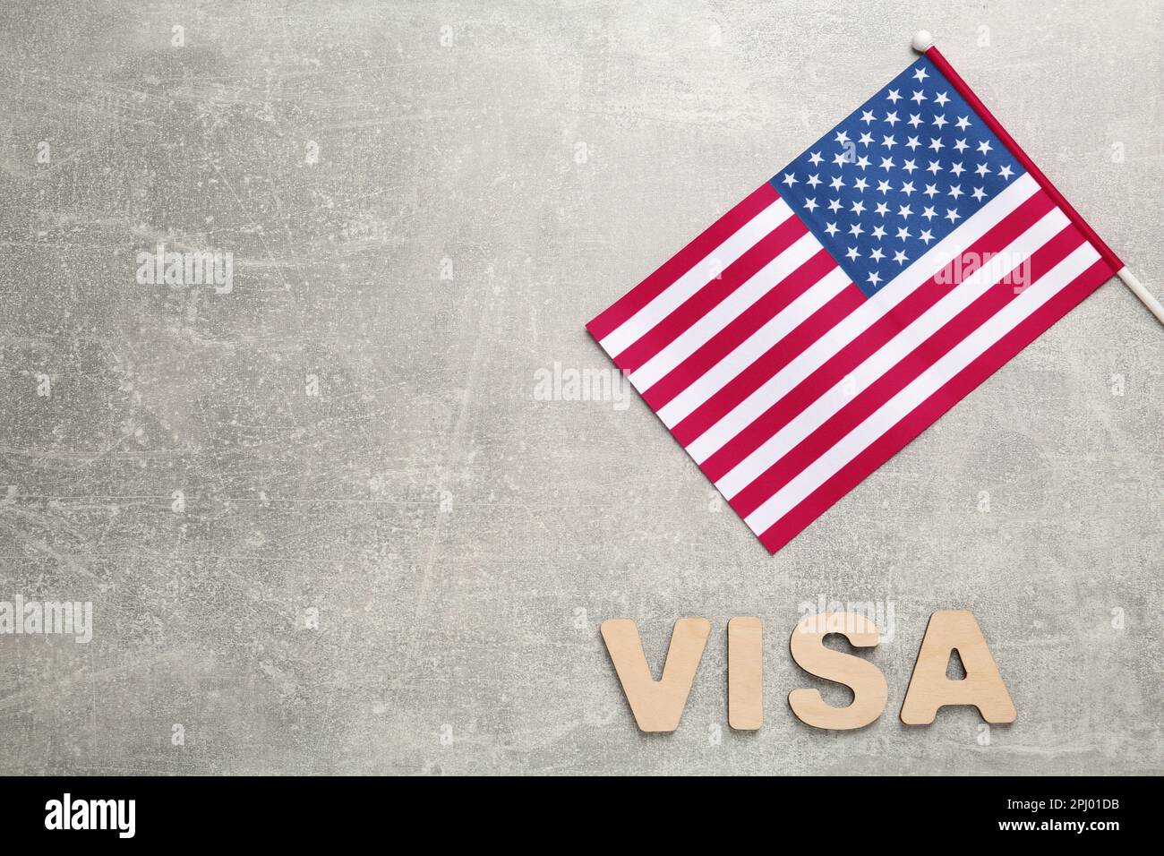 Word Visa and American flag on light grey table, flat lay. Space for ...