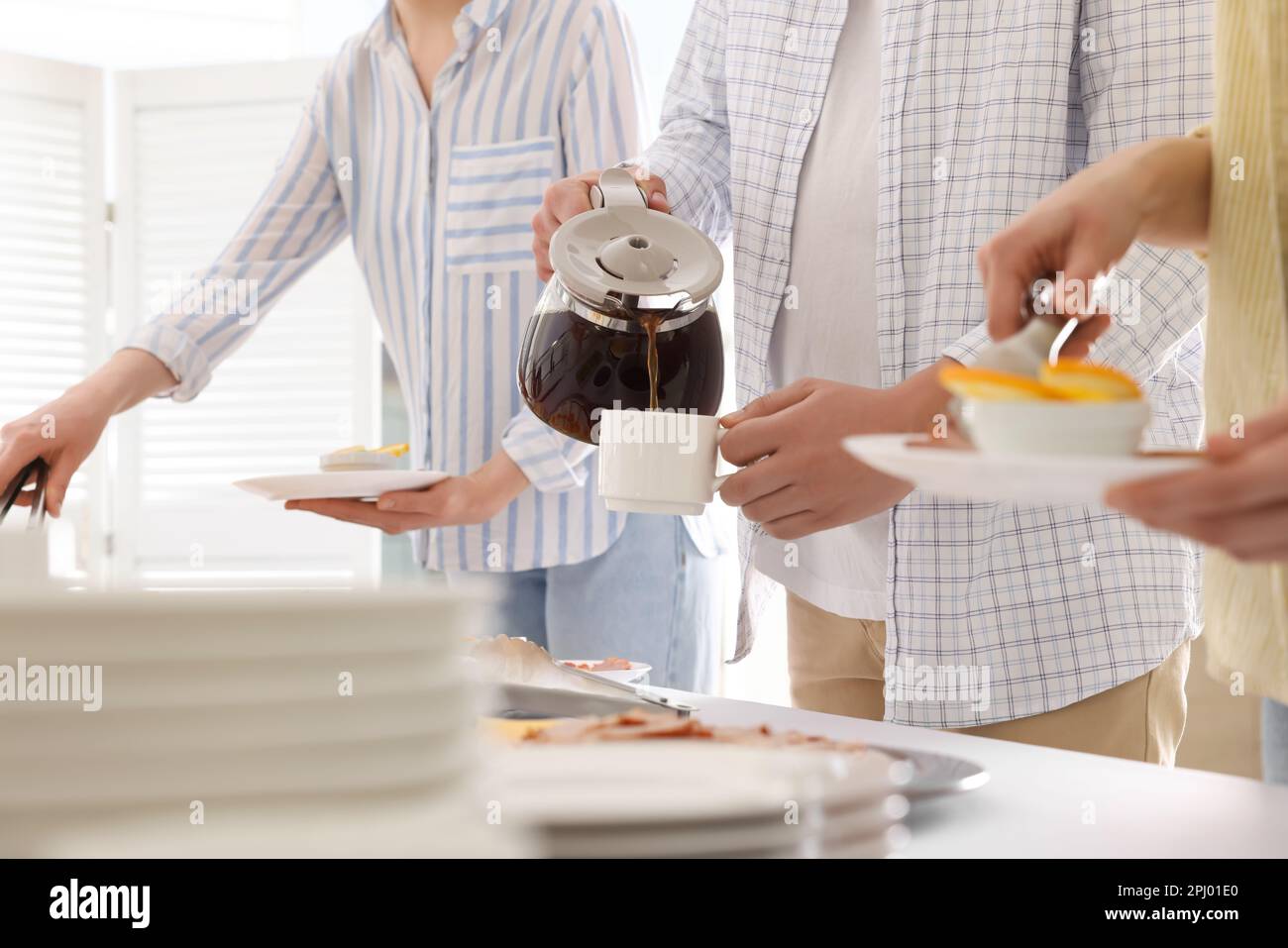 People taking food and pouring coffee during breakfast, closeup. Buffet ...