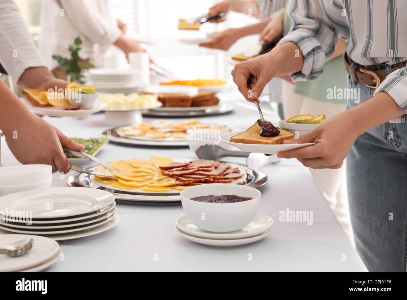 People near table with different dishes during breakfast, closeup ...
