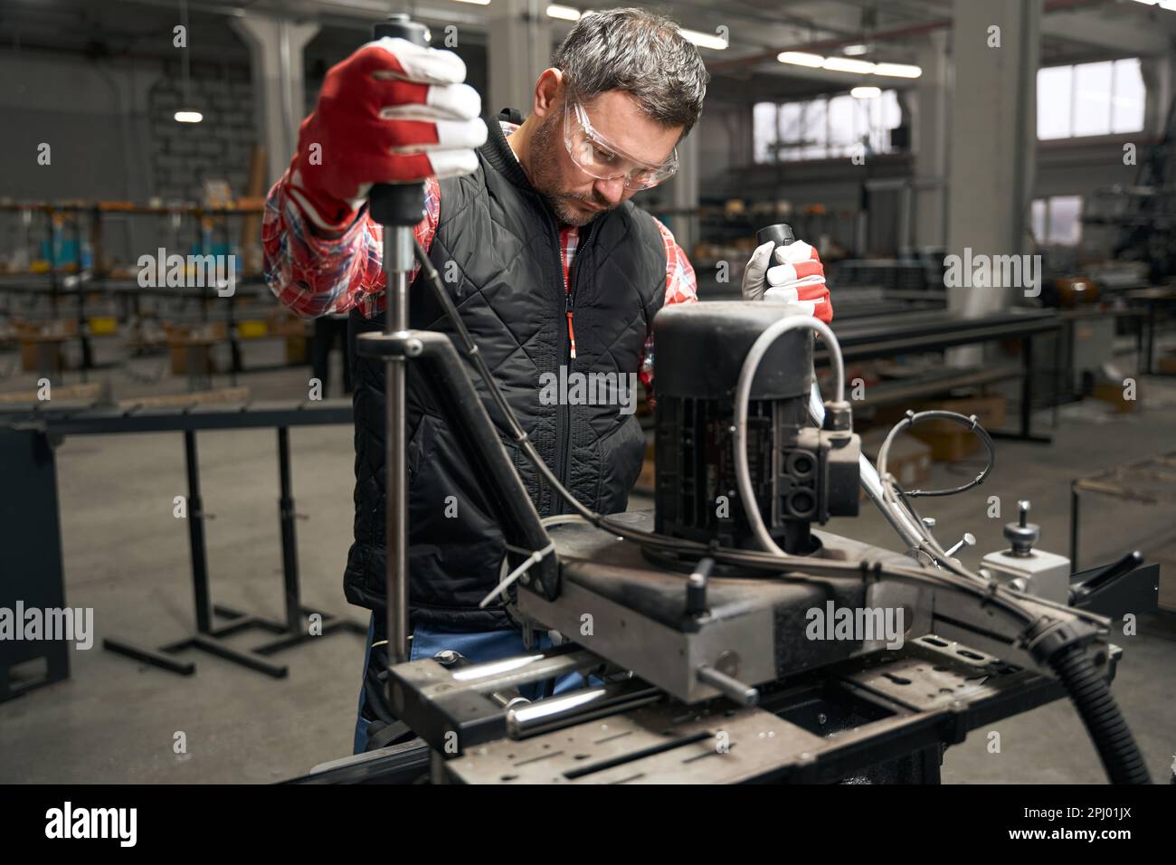 Adult male working on equipment in the workshop Stock Photo - Alamy