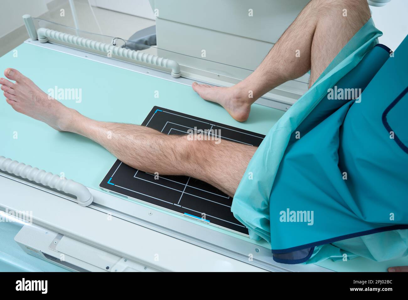 Top view of man sitting on the bed prior to a knee x-ray at the ...