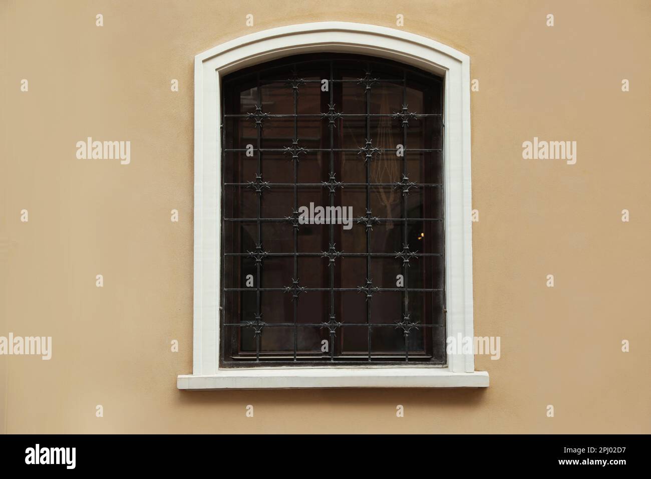 Beautiful arched window with grills in building outdoors Stock Photo ...
