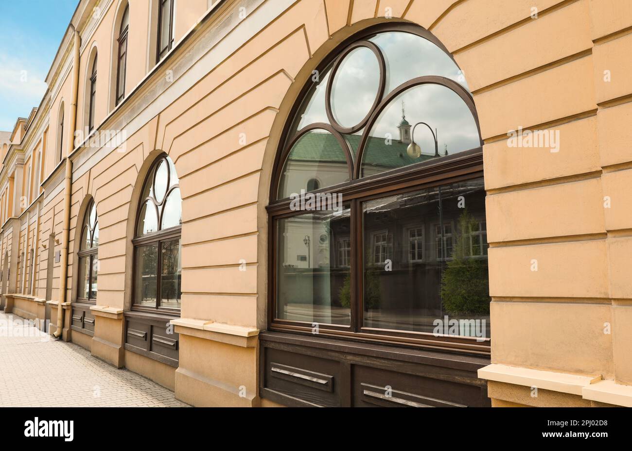 Building with beautiful wooden arch windows on city street Stock Photo ...