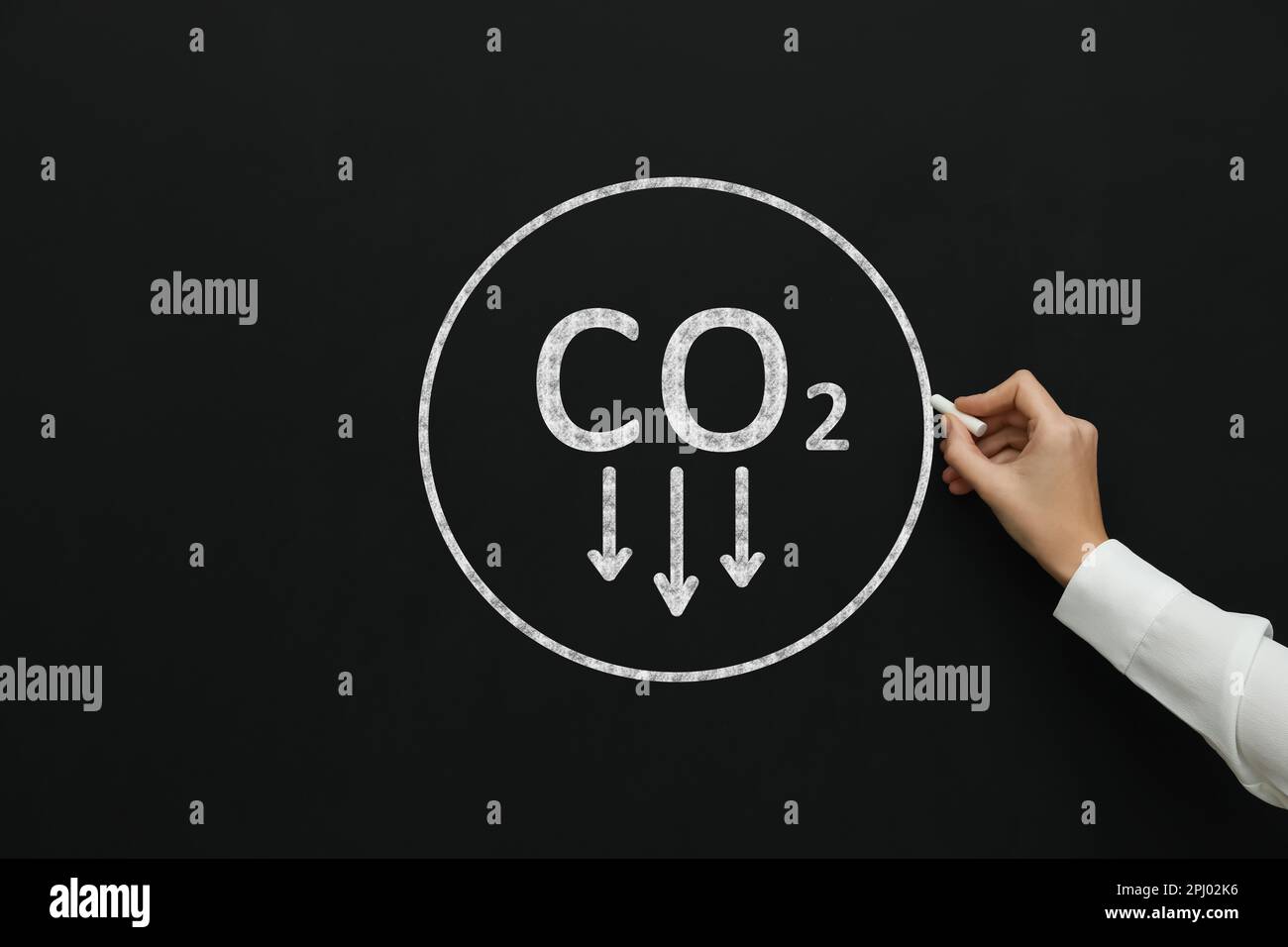 Reduce carbon emissions. Woman drawing circle with chemical formula CO2 ...