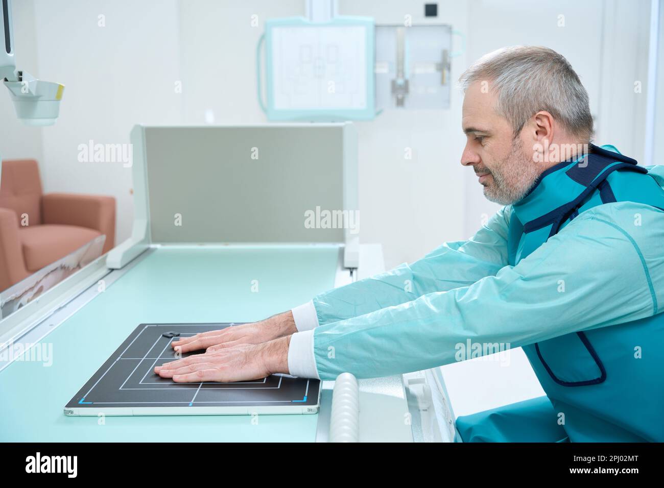 Smiling adult man putting his hands at the special place and making x ...