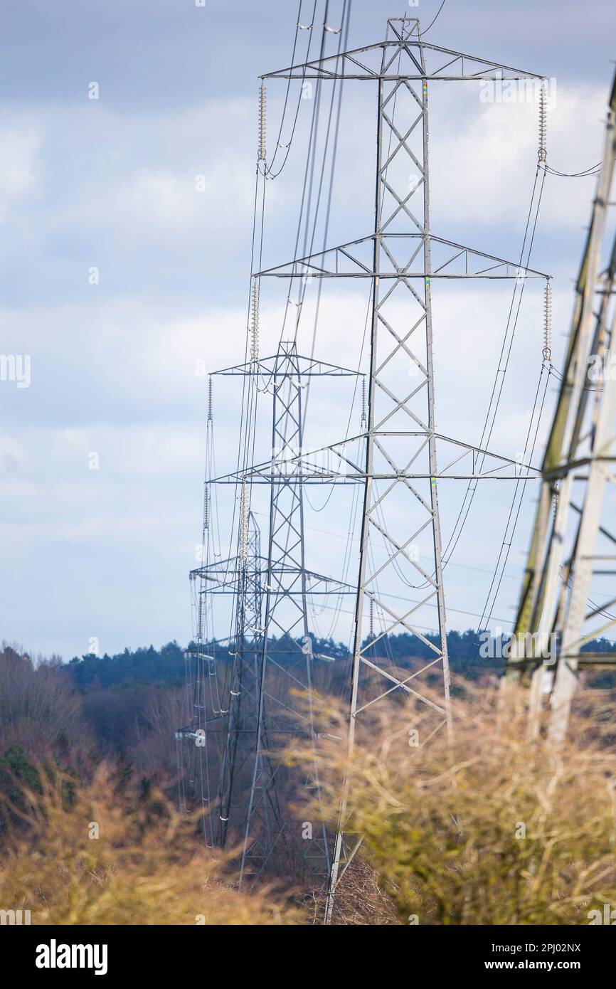 Electricity pylons in UK countryside carrying high-voltage overhead ...