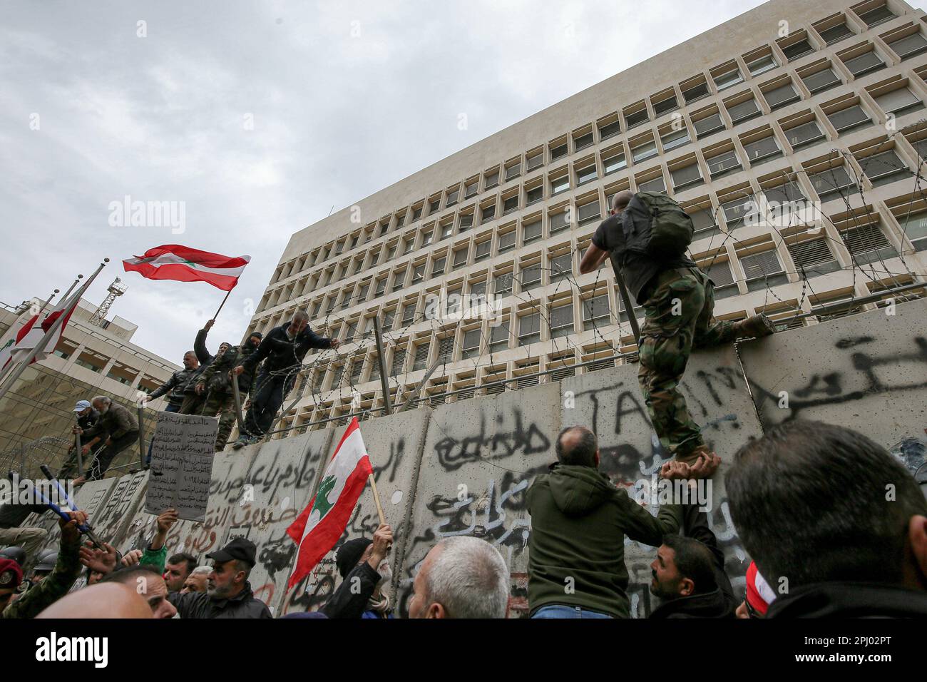 Beirut, Lebanon. 30th Mar, 2023. Lebanese army retirees climb on ...
