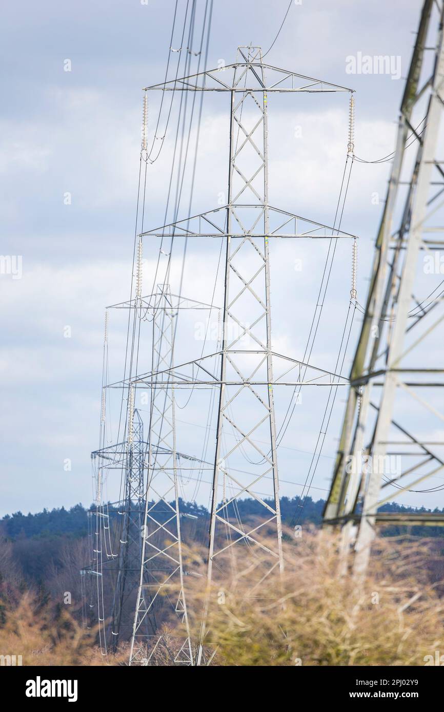 Electricity pylons in UK countryside carrying high-voltage overhead ...