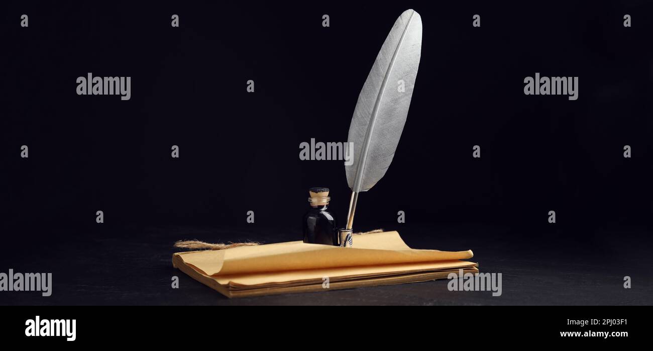 Quill, bottle of ink and old paper on black table. Banner design Stock ...