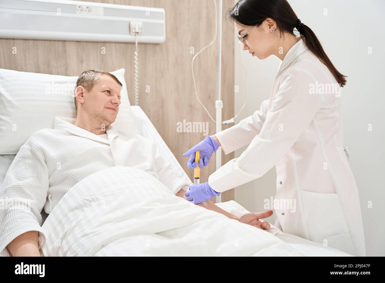 Male getting venous catheter in the vein for blood infusion in medicine ...