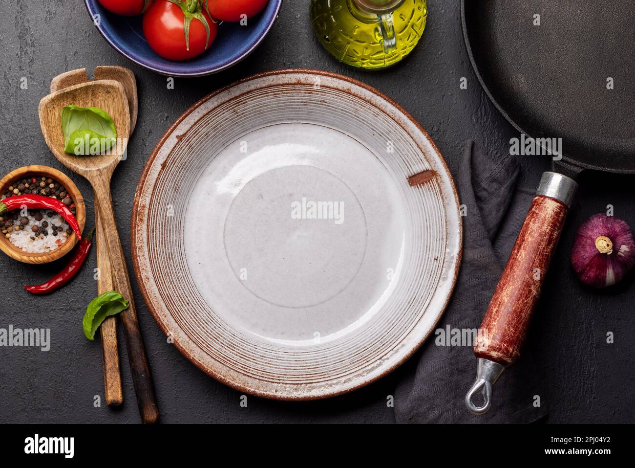 Top-down view of a kitchen table with ingredients, utensils, and empty ...