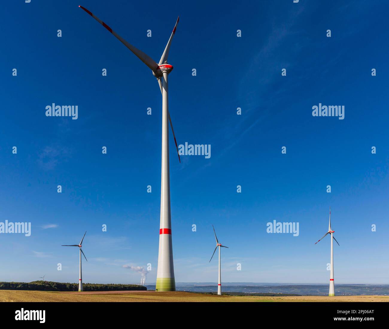 Perl wind turbine, with the Cattenom nuclear power plant in France in ...