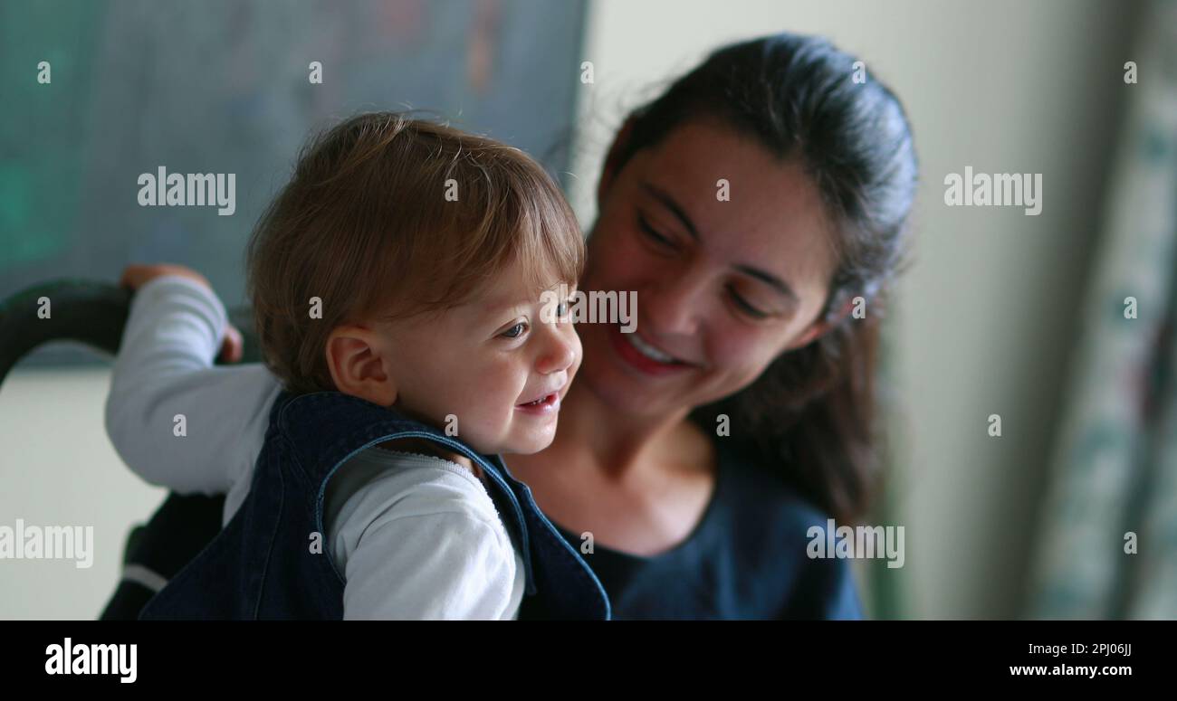 Mother and baby loving relationship. Casual mom real life smiling and ...