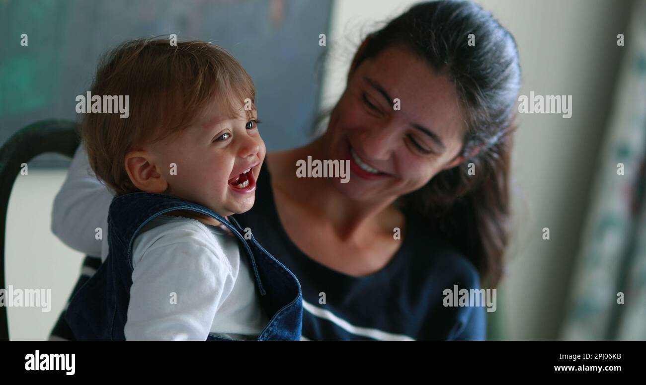 Mother and baby loving relationship. Casual mom real life smiling and ...