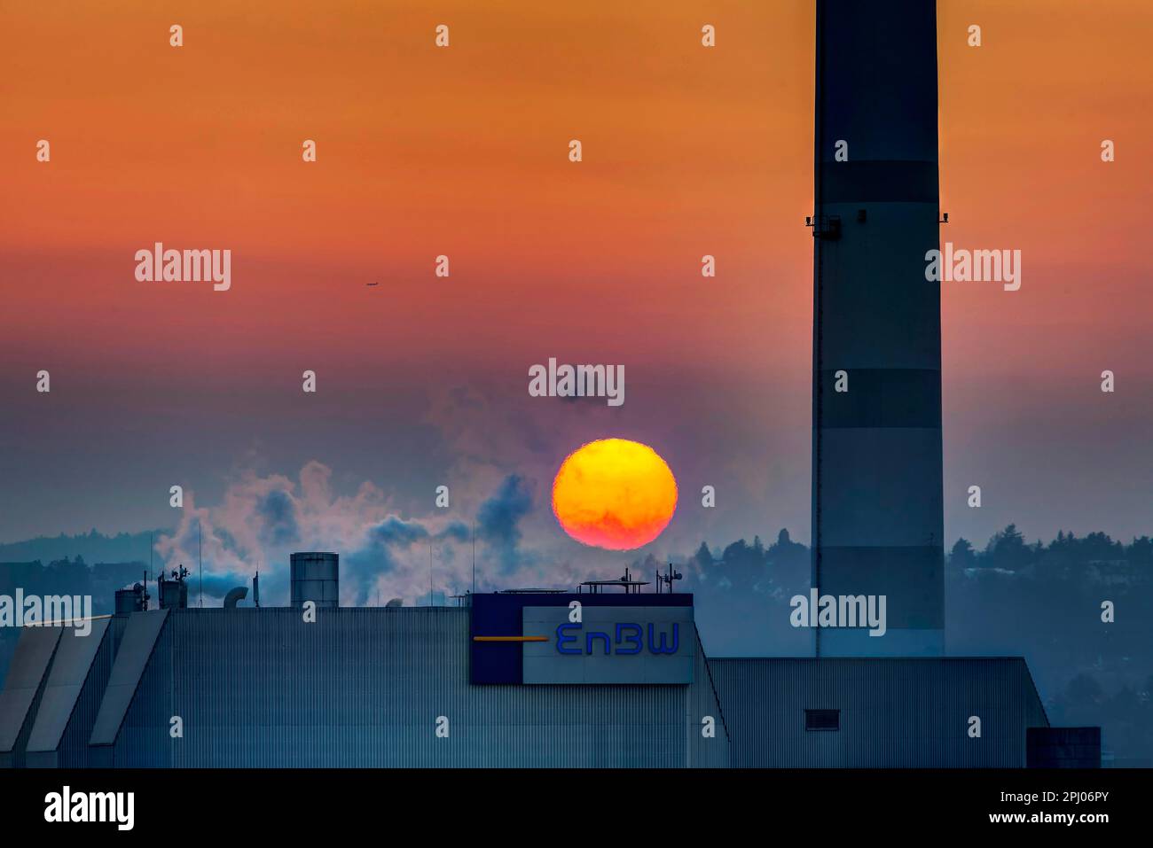 Sunset, smog, the sun sets behind the residual waste combined heat and ...