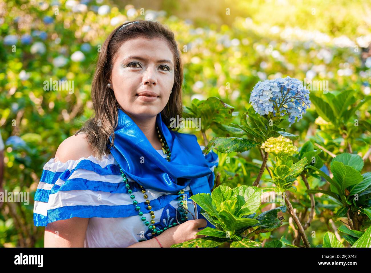 Portrait Of Smiling Woman In National Folk Costume In A Field Of