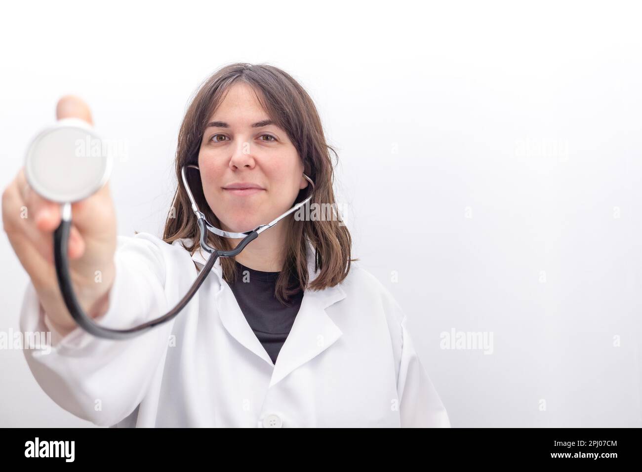 Close-up Front view of a young female doctor showing stethoscope ...