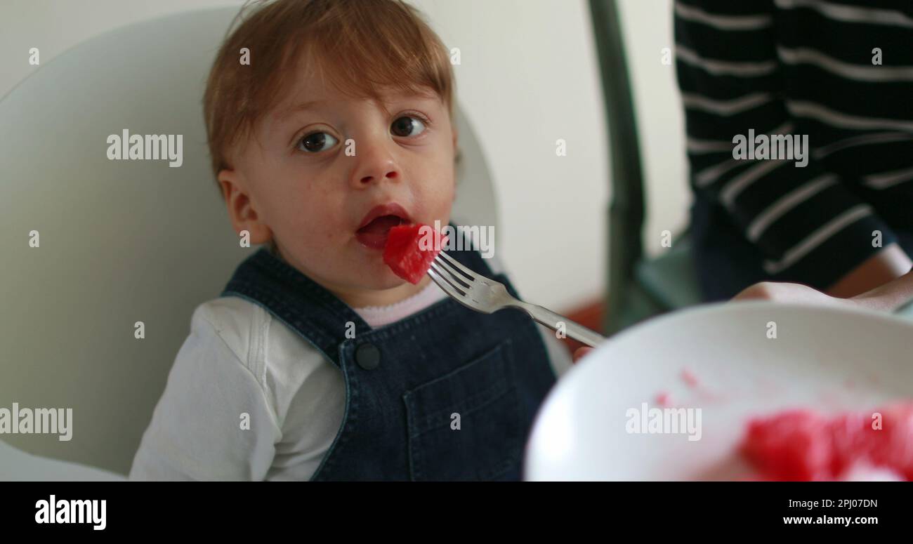 Mom giving healthy fruit dessert to infant todlder. Baby eating ...