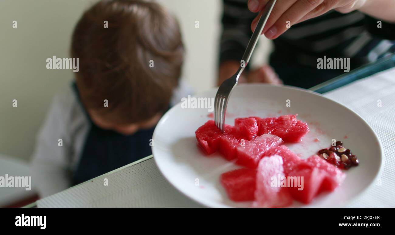 Mom giving healthy fruit dessert to infant todlder. Baby eating ...