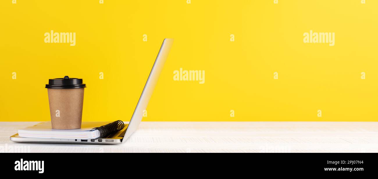 Laptop, notepad and coffee cup. Computer on desk with blank space for ...