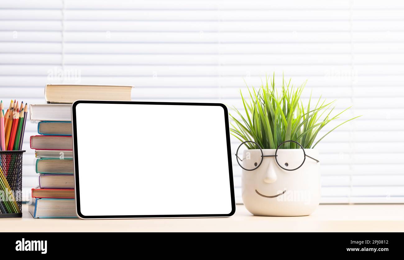 Tablet and stack of books. With blank screen for your text or app Stock ...