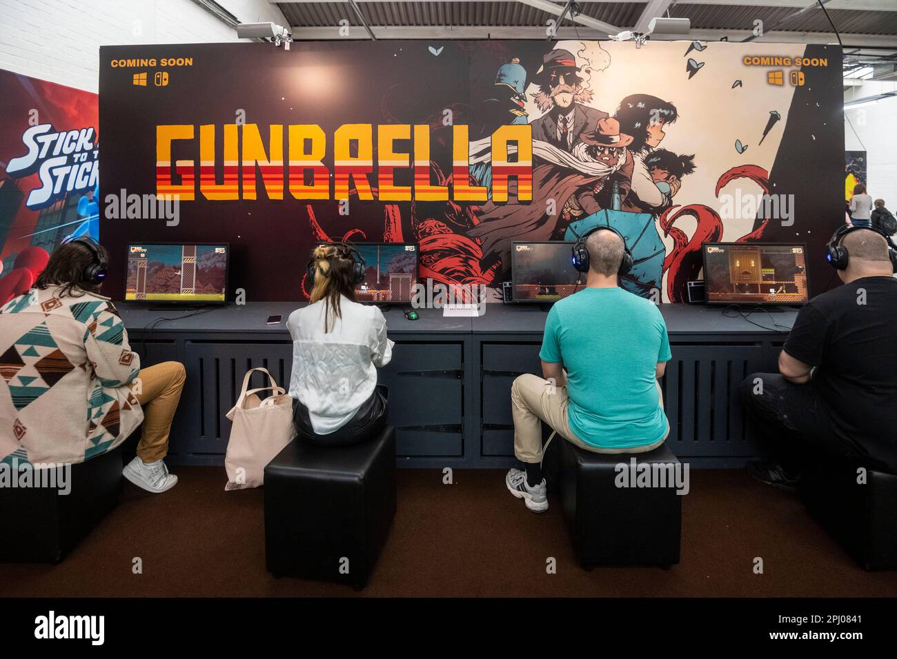 London, UK. 30 March 2023. Visitors play 'Gunbrella' by Devolver Digital at the W.A.S.D. Video ...