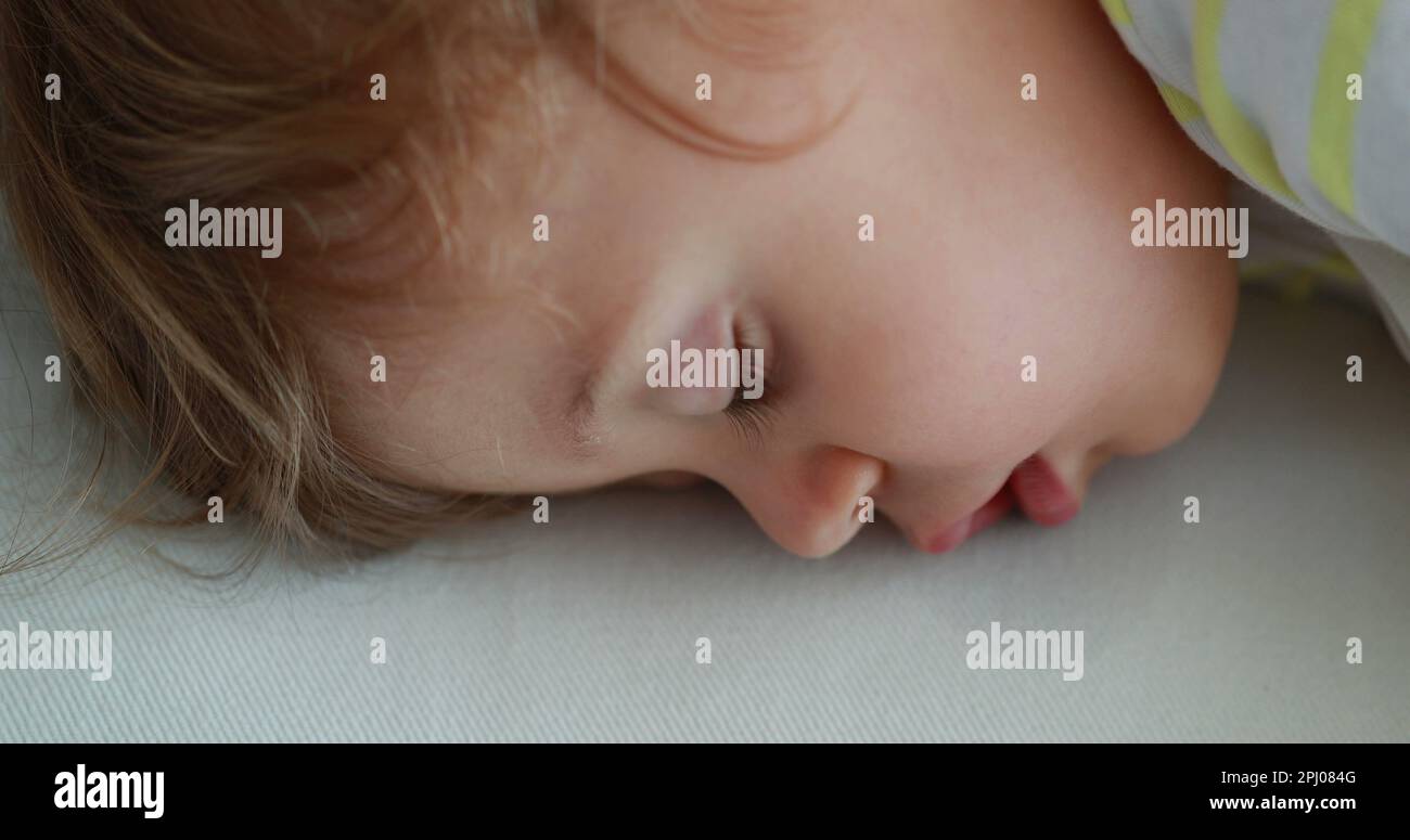 Infant baby drooling during afternoon nap Stock Photo - Alamy