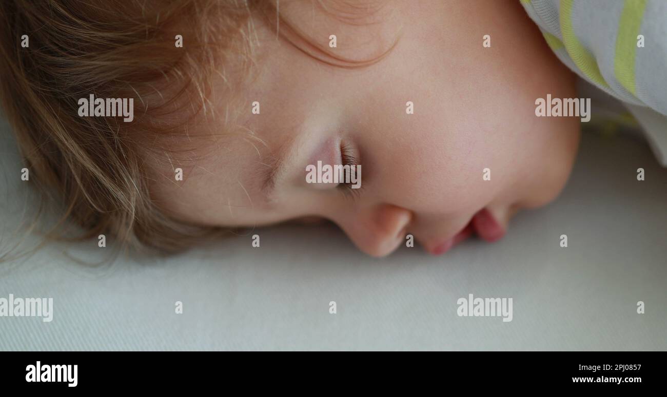 Infant baby drooling during afternoon nap Stock Photo - Alamy