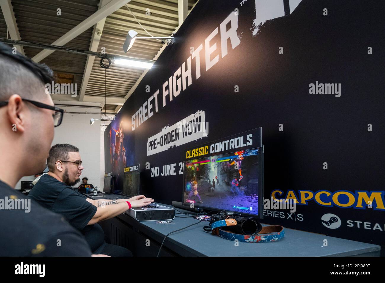 London, UK. 30 March 2023. Visitors play the upcoming 'Street Fighter 6 ...