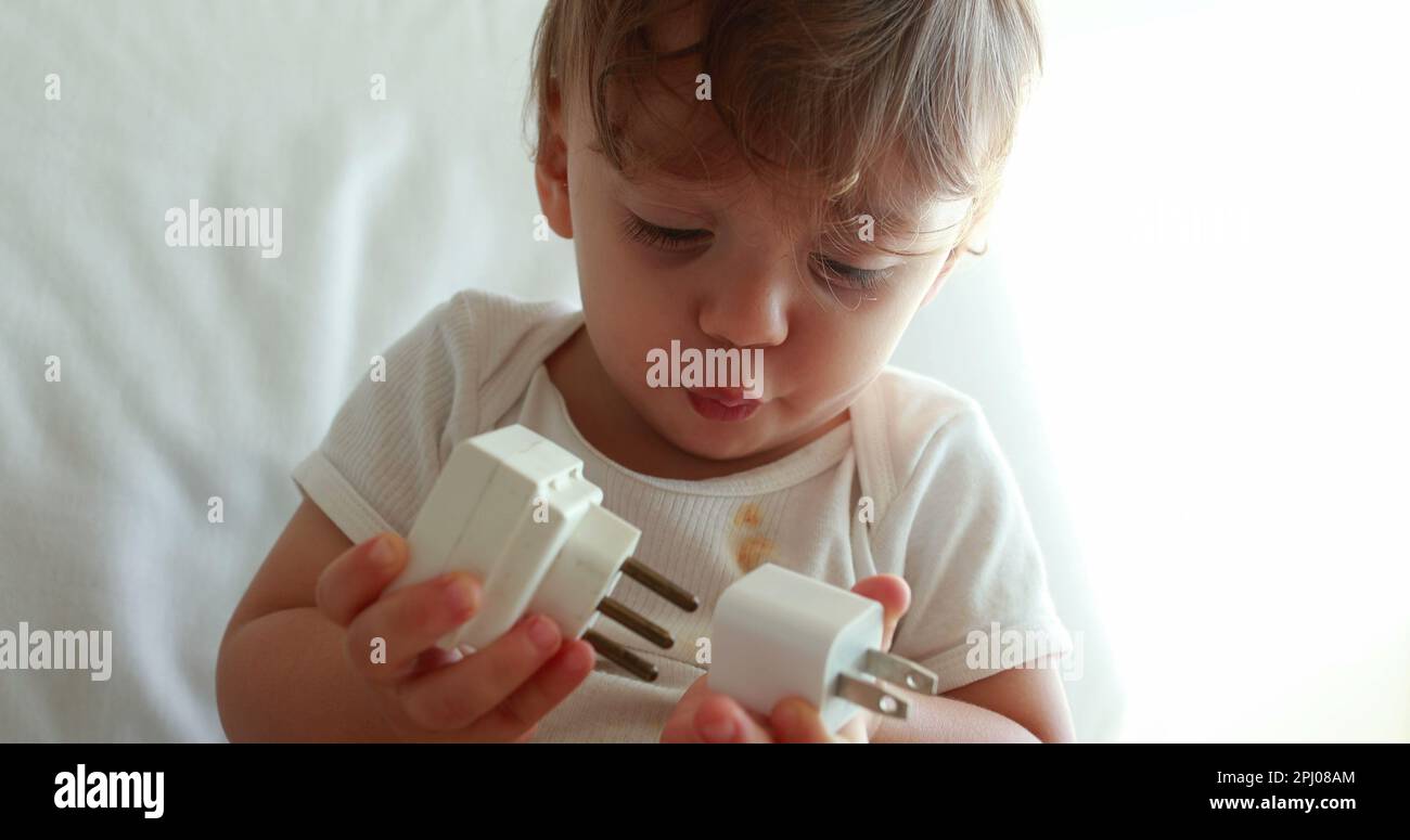 Cute baby playing with connectors appliances Stock Photo - Alamy