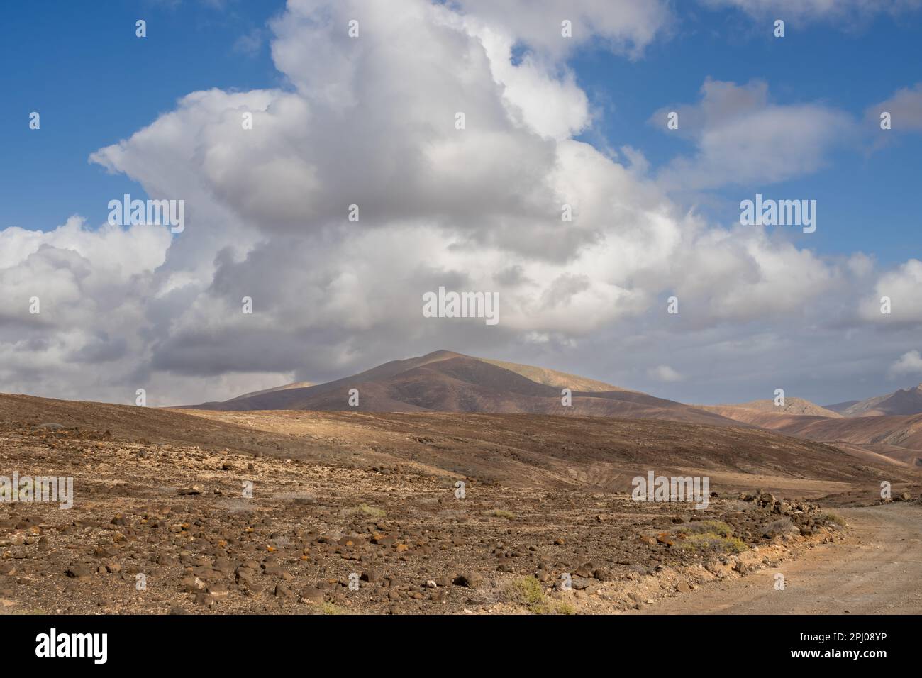 Dry volcanic mountains in the west of the island. Country gravel road ...
