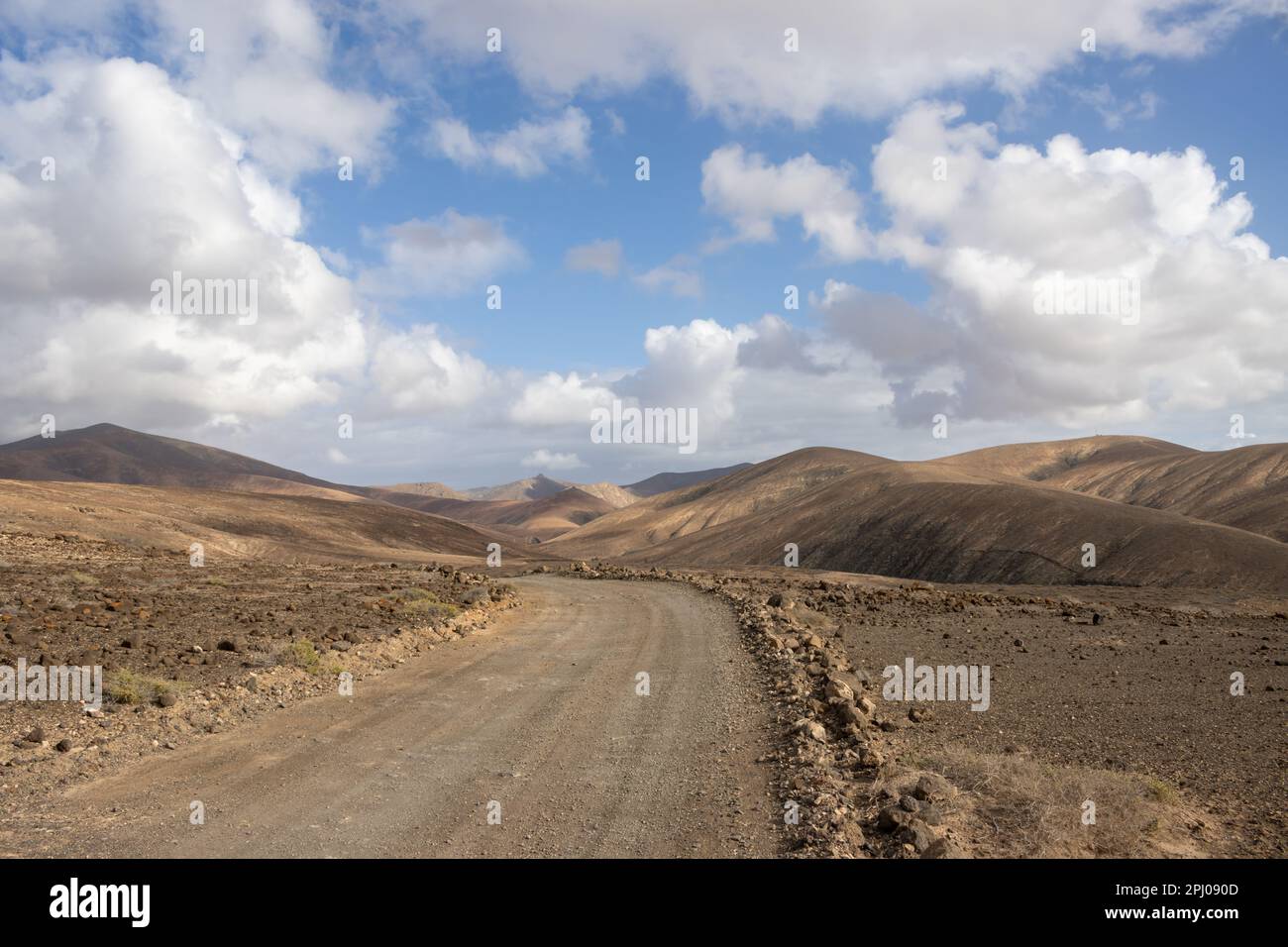 Dry volcanic mountains in the west of the island. Country gravel road ...