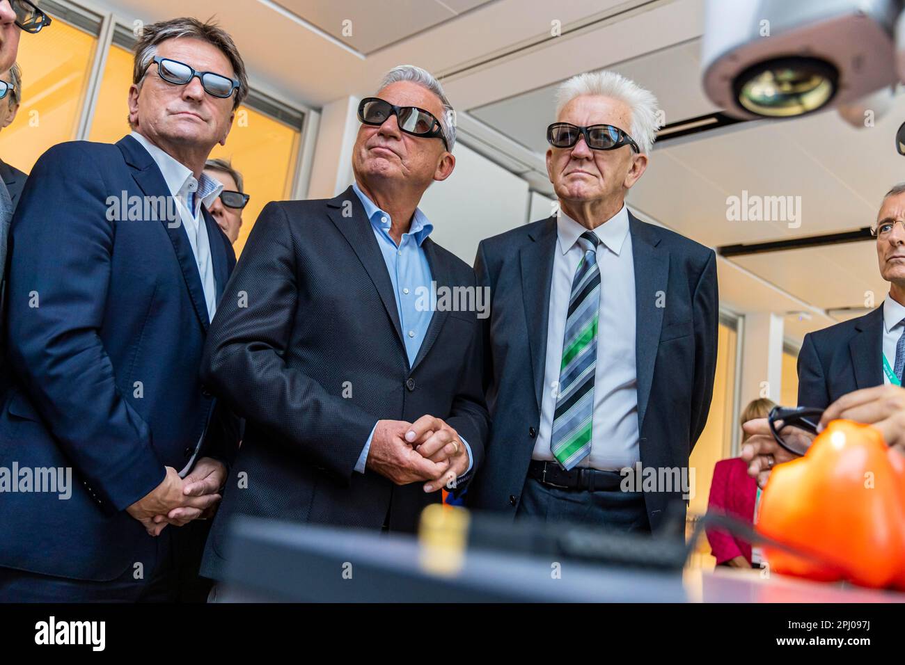 Three ministers wearing black 3D glasses. From right, Minister ...