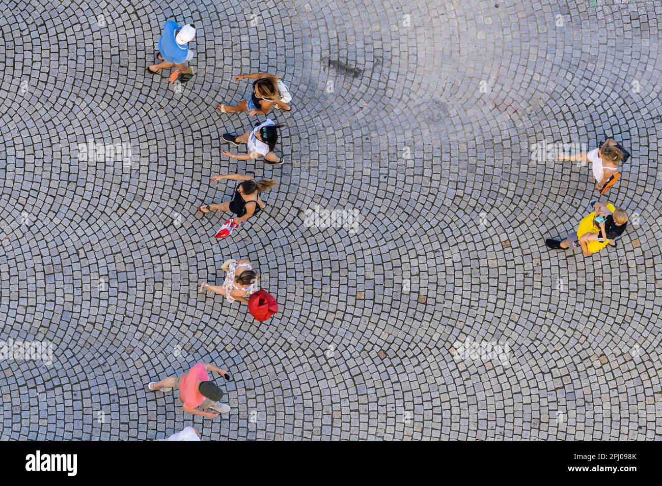 Birds eye view of people, a group of people walking across a square ...