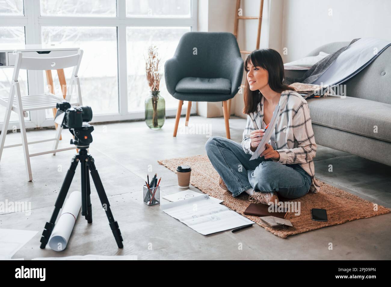 Makes content for blogging. Camera on the floor. Young female freelance ...