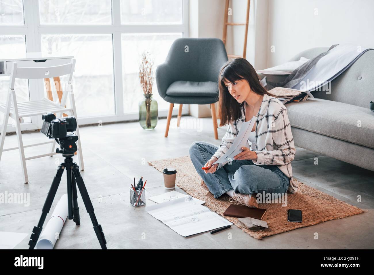 Makes content for blogging. Camera on the floor. Young female freelance ...