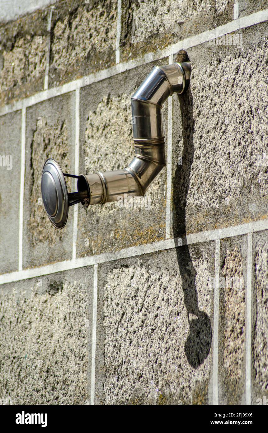 pellet stove fireplace on a granite stone façade Stock Photo - Alamy
