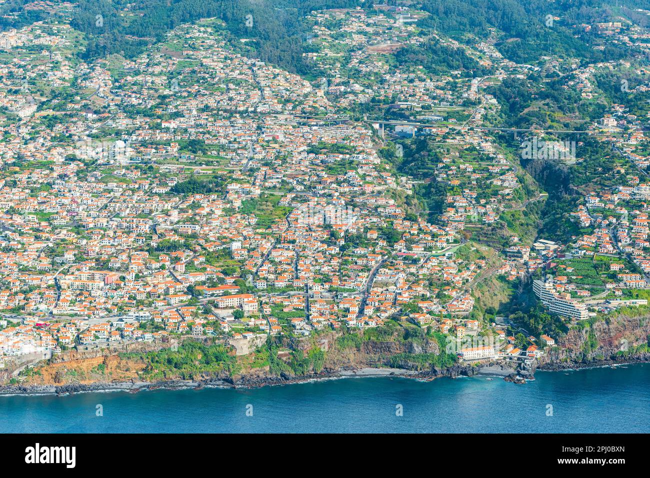 A captivating aerial view of Funchal, Madeira; lush green hills ...