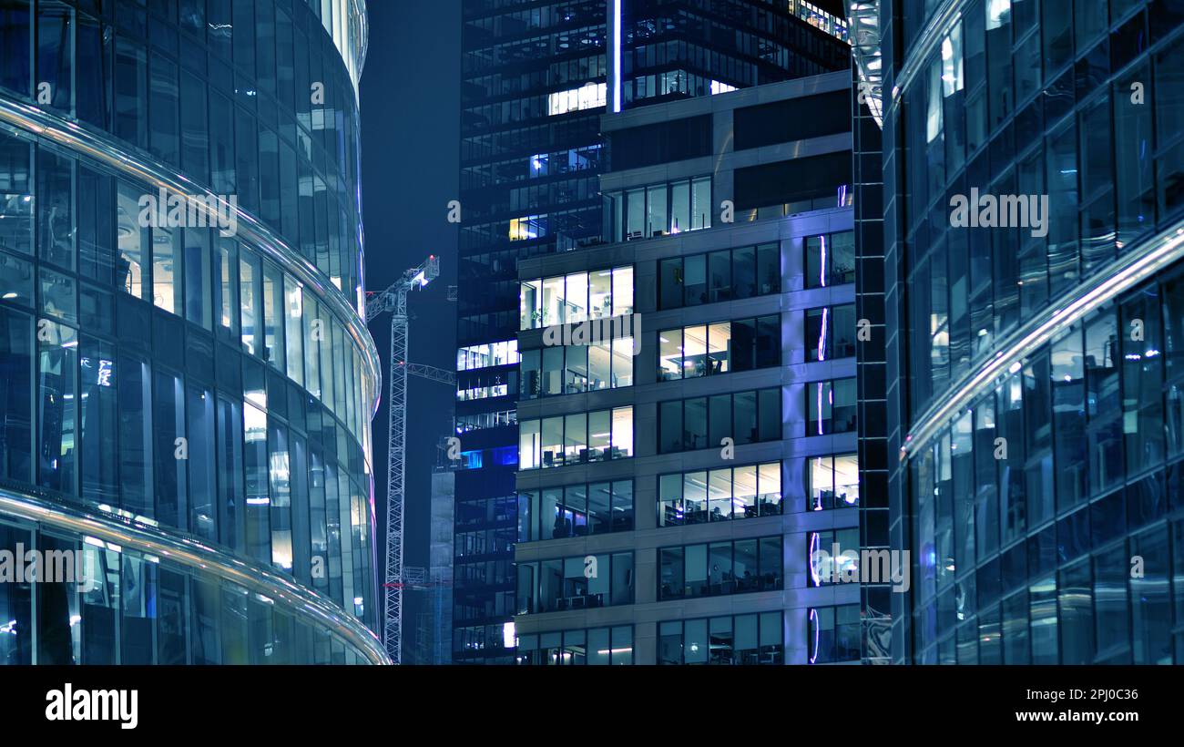 Pattern of office buildings windows illuminated at night. Glass ...