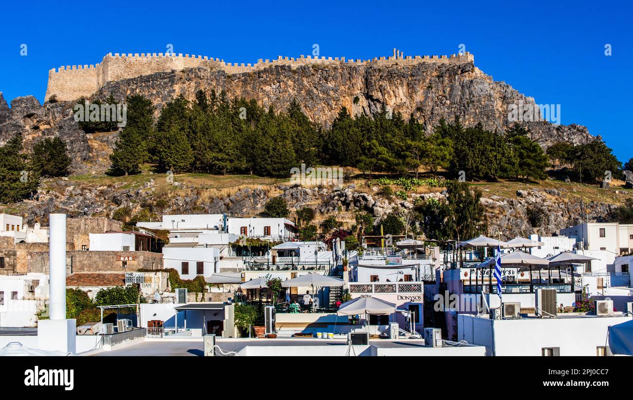 Acropolis of Lindos on a steeply rising cliff above the town, Rhodes ...