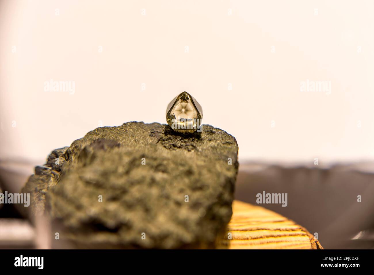 Diamond with inclusion, star in rough diamond, in front of magnifying ...
