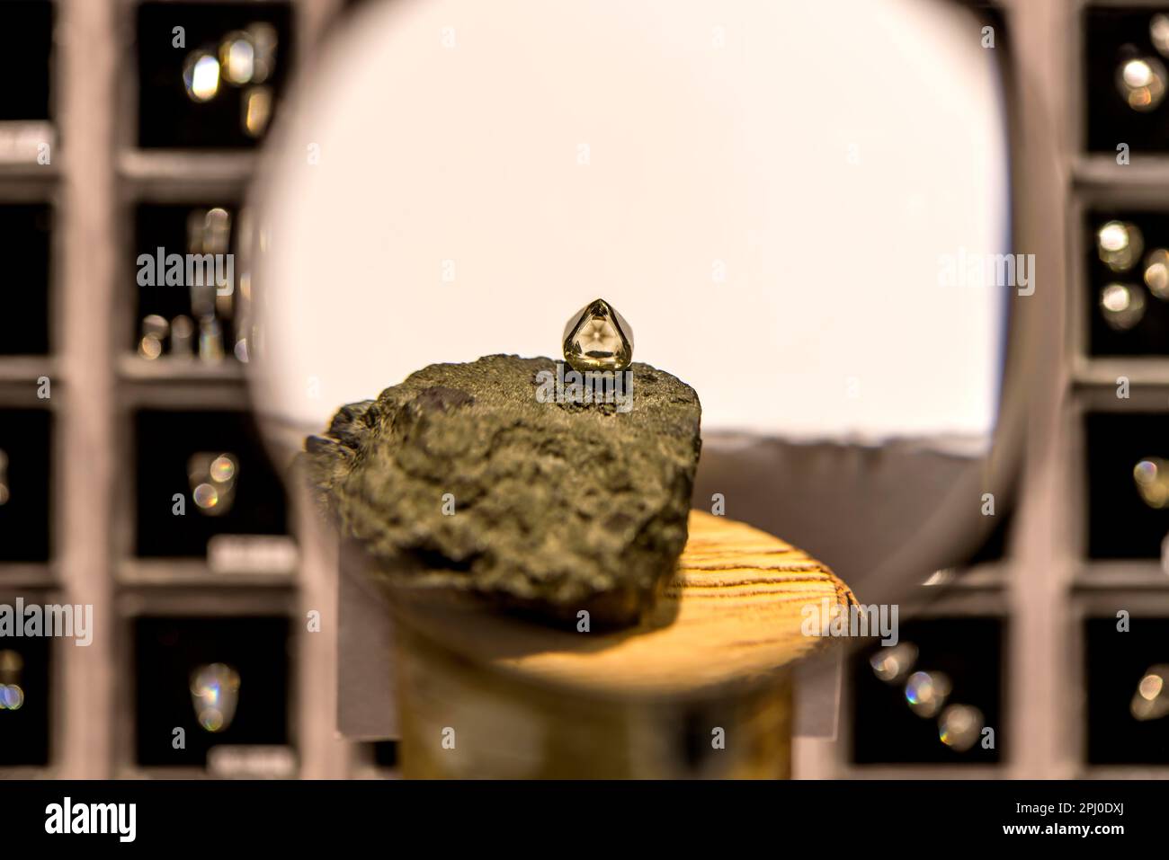 Diamond with inclusion, star in rough diamond, under magnifying glass ...